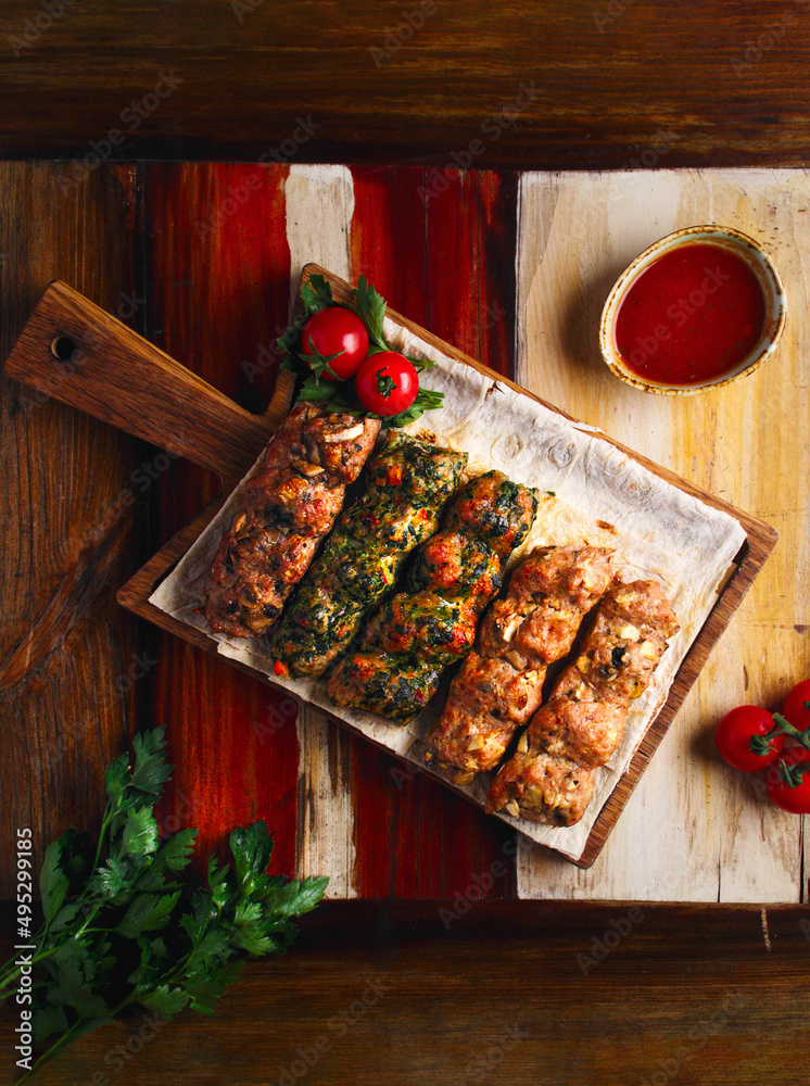 Fotka „Assorted lula kebab on pita bread. Grilled lamb kebab with ...