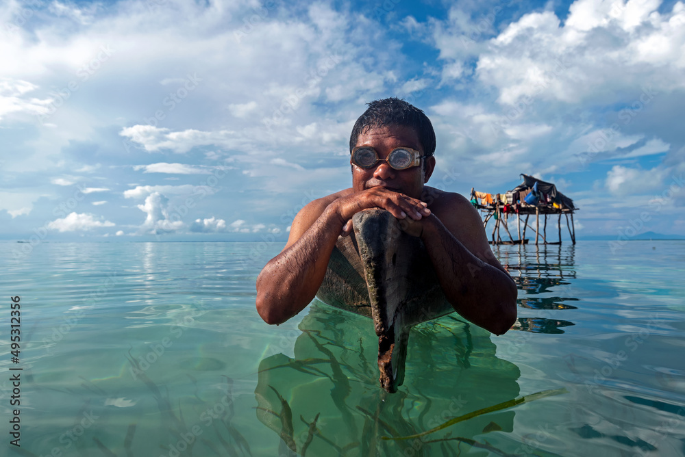 Portrait of Bajau Laut or Sea Gypsy man on a boat with scuba glass in ...