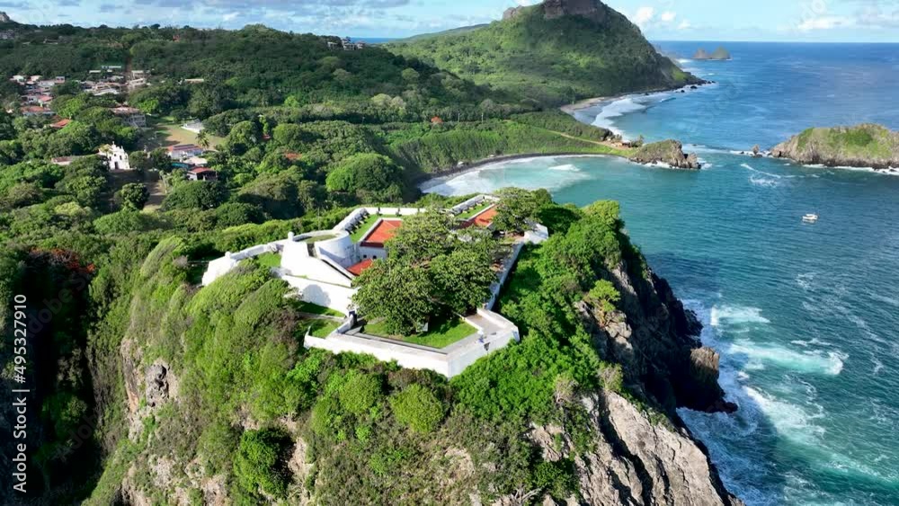 Island of Fernando de Noronha Brazil. Military fort with weapons at vulcano mountain at ...