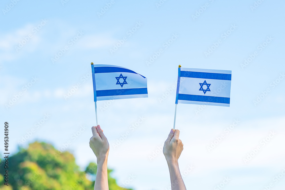 hand holding Israel flag on nature background. Israel Independence day ...