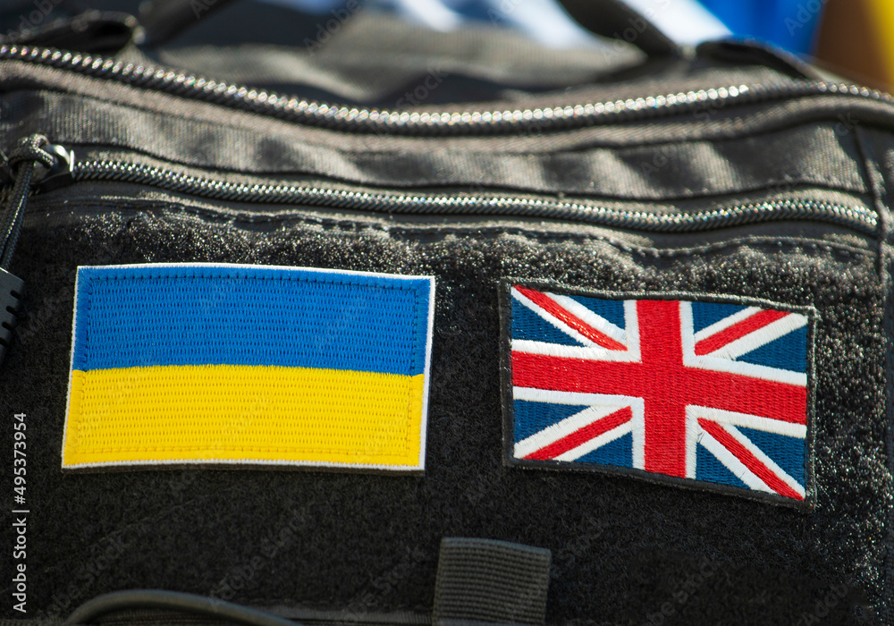 Small cloth badges of the Ukrainian and UK national flags, side by side ...