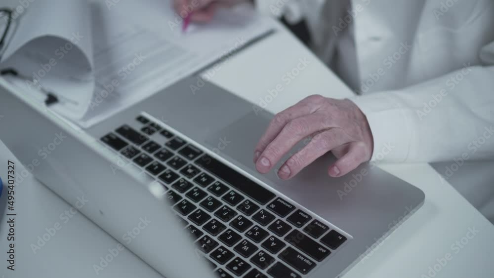Senior woman doctor hands using laptop computer and working on ...