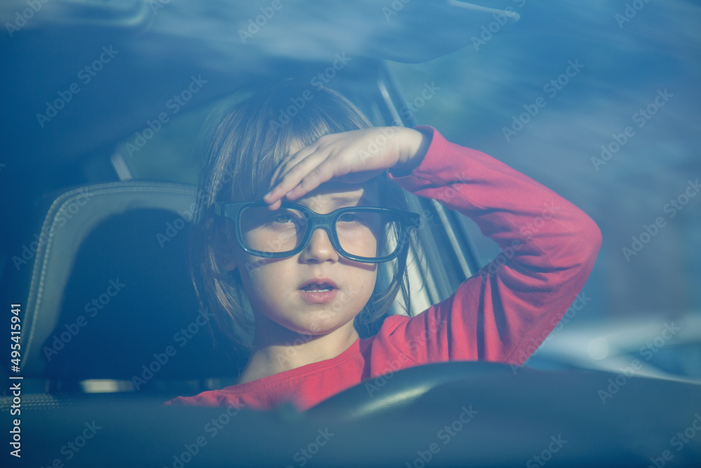 Dangers and risks of underage driving. Portrait of young girl drives a ...