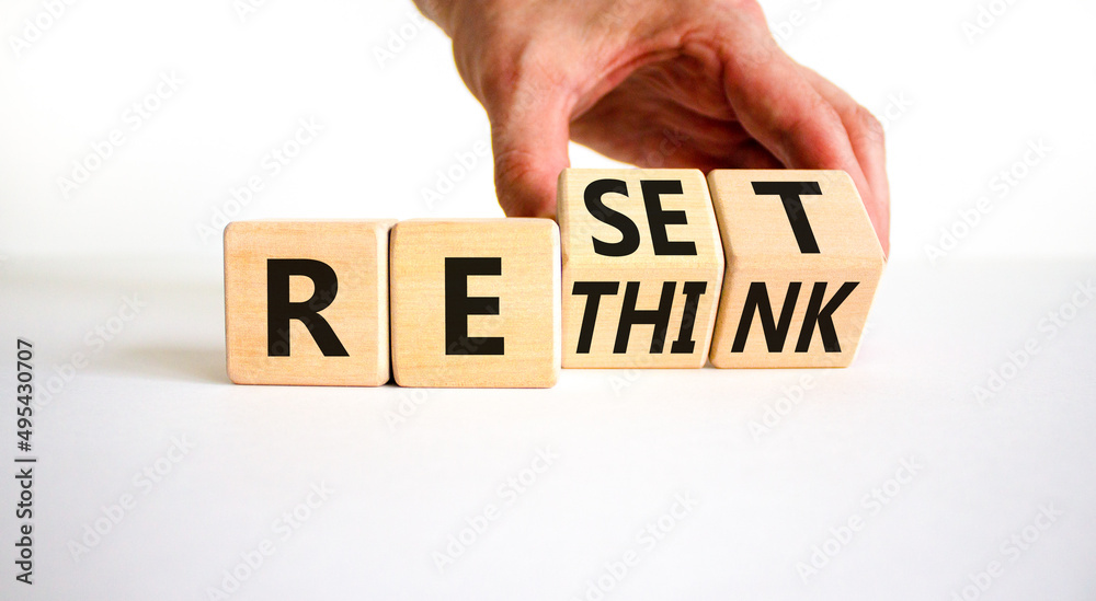 Rethink and reset symbol. Businessman turns wooden cubes and changes ...