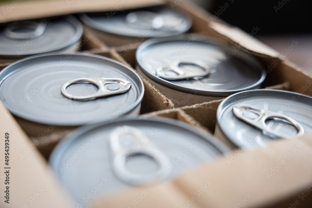 Food cans in an open cardboard box. Concept image for supply chain ...