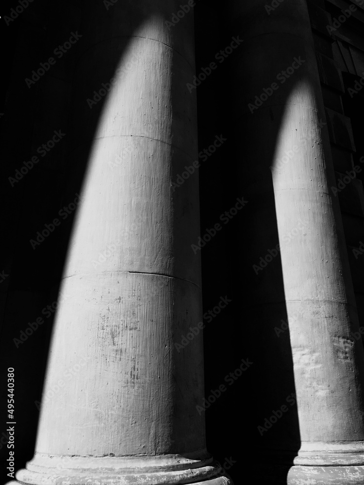 Grayscale photo of shadow on pillars Stock Photo | Adobe Stock