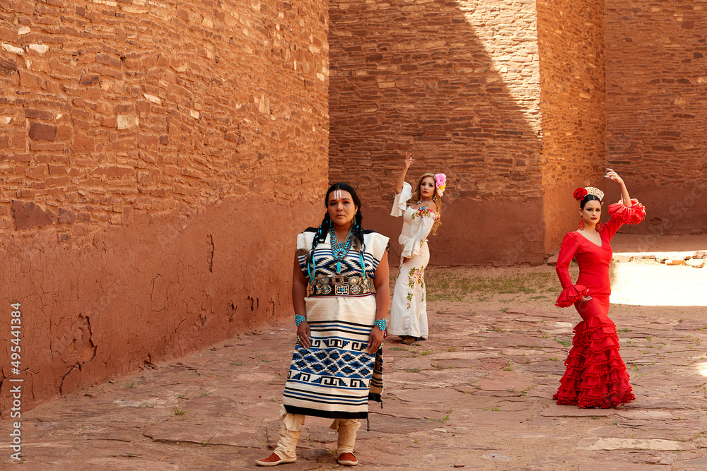 Indigenous American woman in traditional outfit and two Spanish women ...
