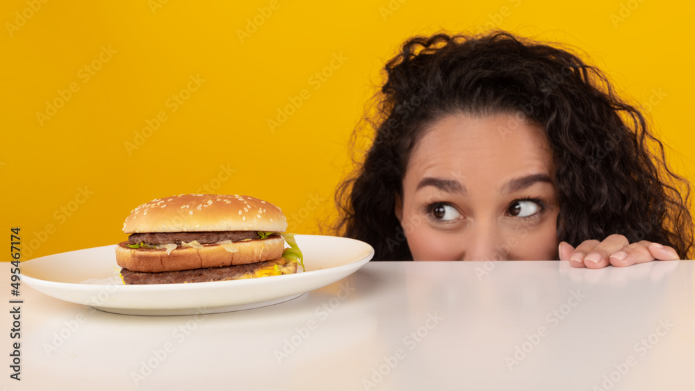 Hungry Lady Looking At Burger Peeping Out Table Stock Photo | Adobe Stock