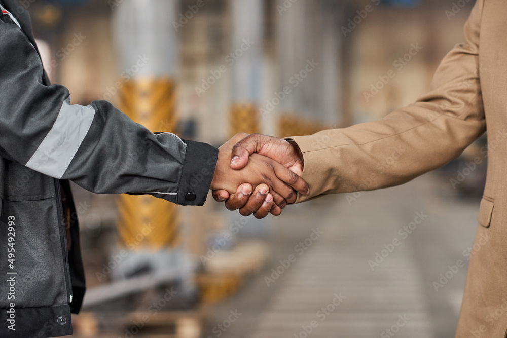 Close-up of manager shaking hands with the worker to apply him for a ...