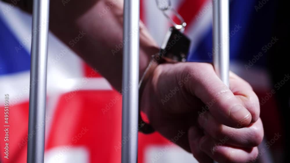 Prisoner in handcuffs through prison bars vídeo de Stock | Adobe Stock