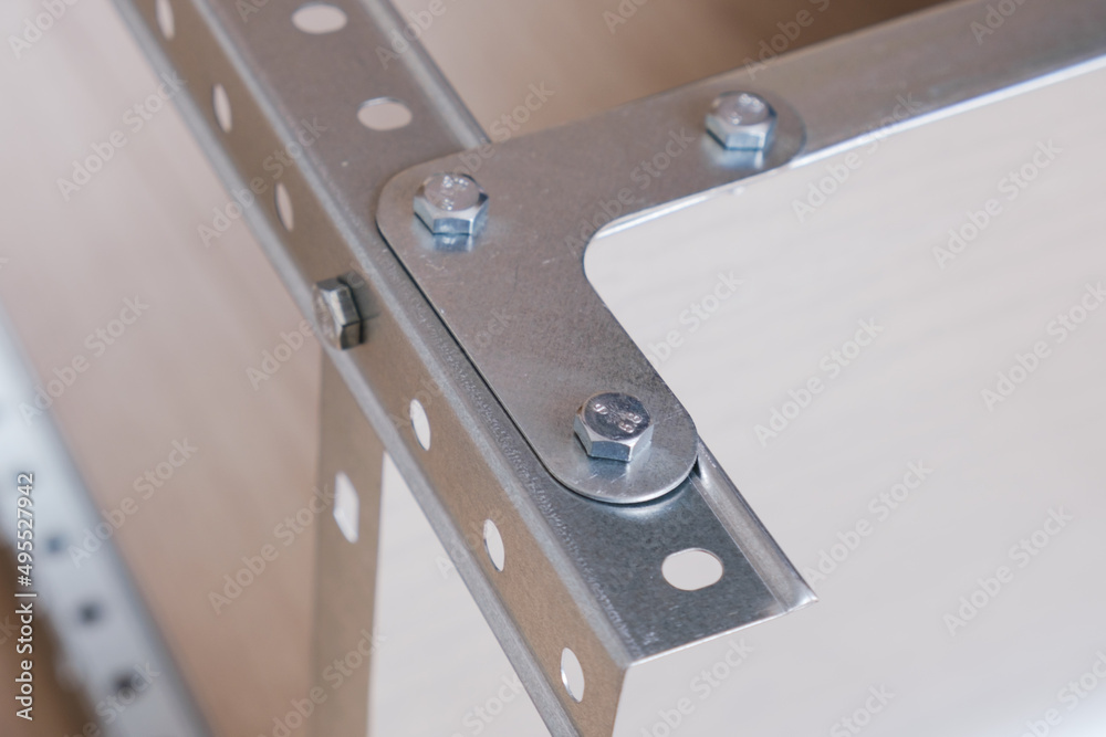 Metal L-shaped corner bracket for fixing parts of a prefabricated ...