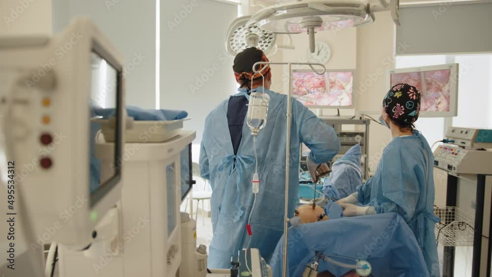 Team surgeon at work on laparoscopy operating in hospital. Surgeon ...