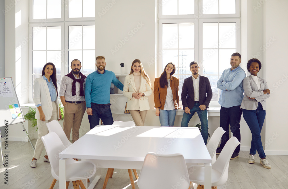 Portrait of diverse smiling multiracial businesspeople pose together in ...