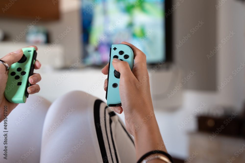 young girl playing at home with Nintendo Switch special edition ...