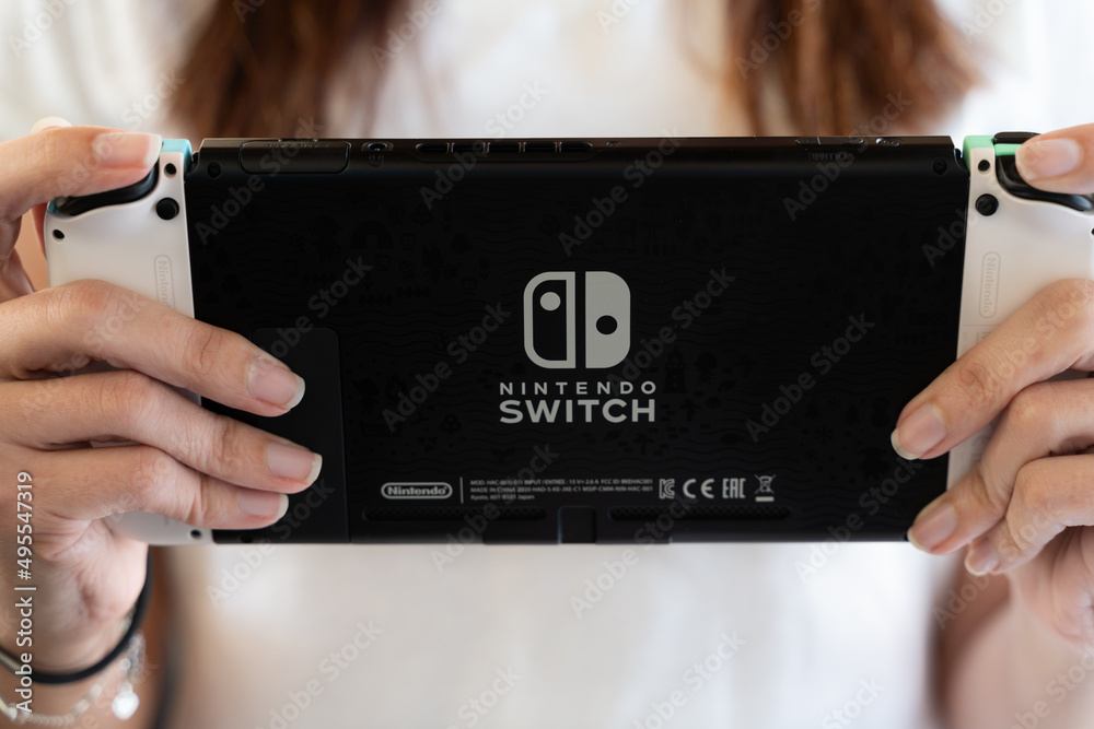 ~young girl plaing with a Nintendo Switch Stock Photo | Adobe Stock