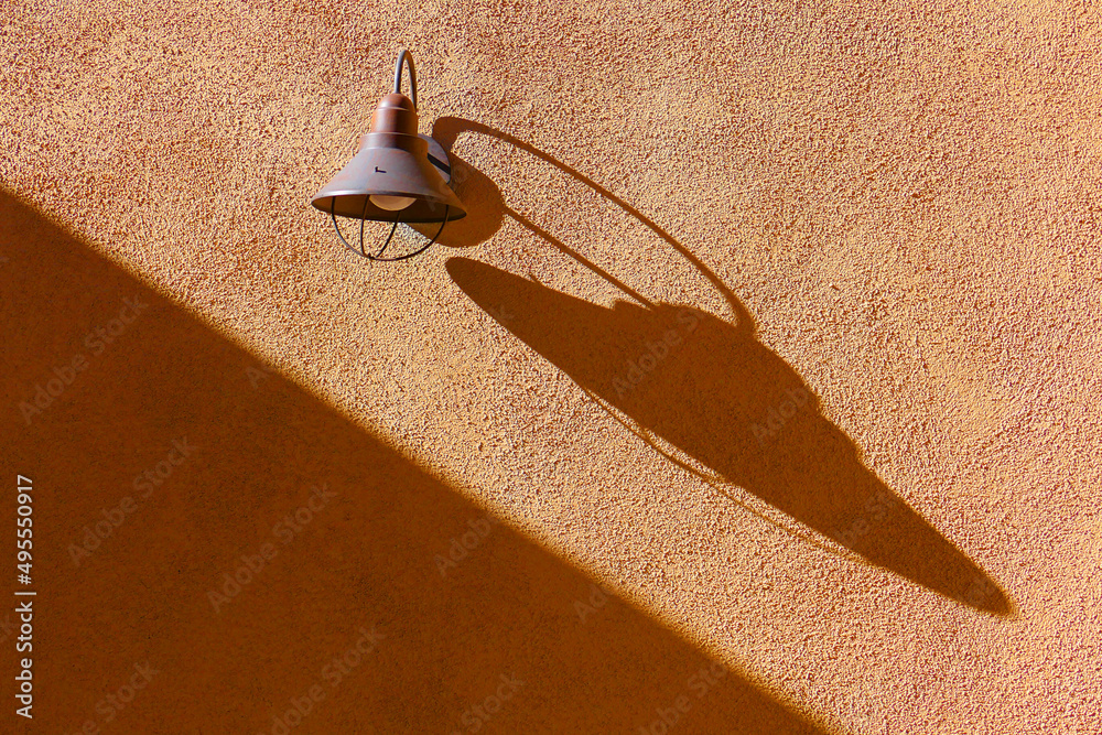 Shadow Play - Late day sun casting shadows from building an porch light ...