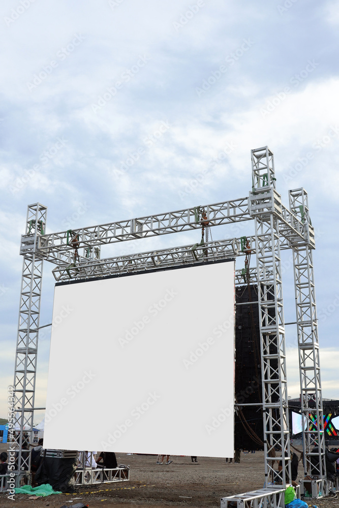 Large blank open-air outdoor white screen for public event such as ...