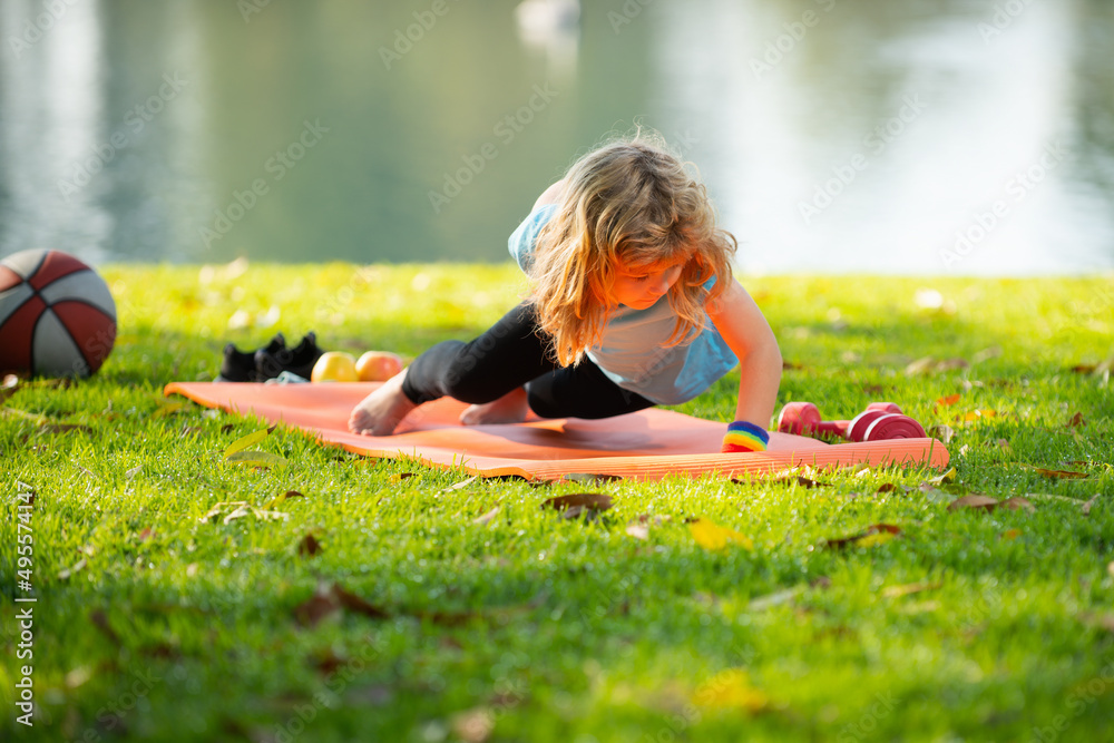 Kid pushing up. Boy doing push up exercise outdoors. Healthy lifestyle ...