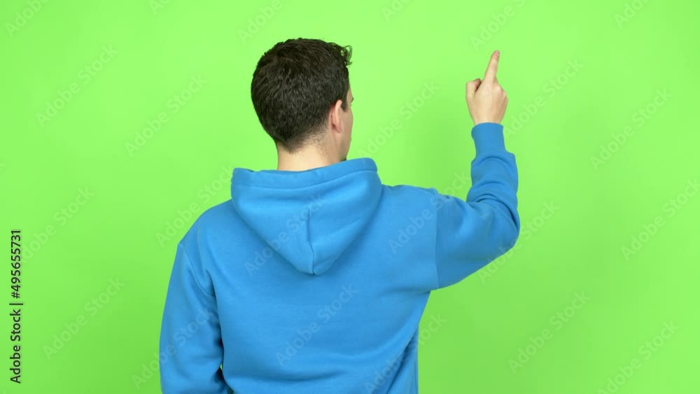 Vidéo Stock Man pointing back with the index finger over isolated ...