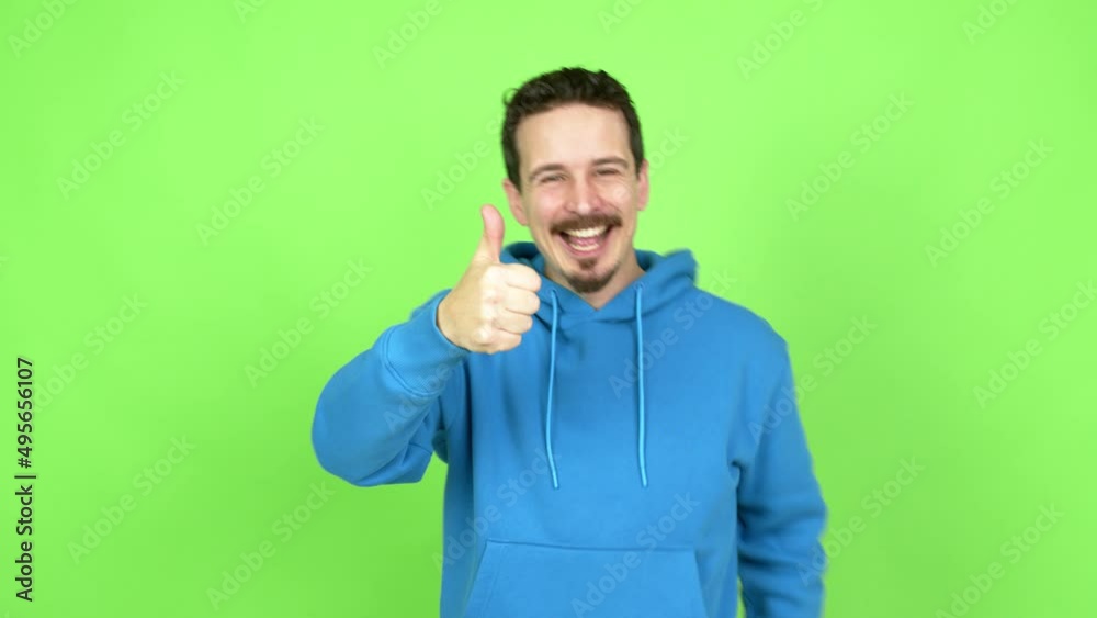 Man giving thumbs up and smiling because something good has happened ...