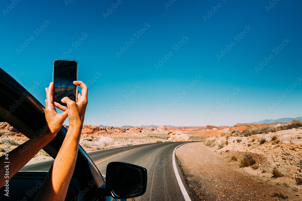 Person reaching out from a window to take a photo on a trail through ...