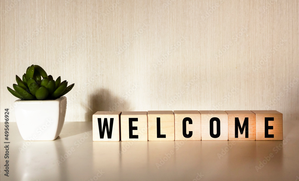 Symbol of welcome and support. Concept welcome on wooden cubes ...