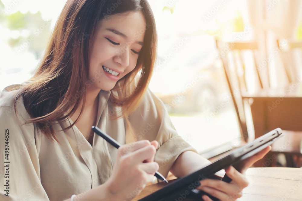 girl taking notes on her tablet She is planning a presentation for her ...