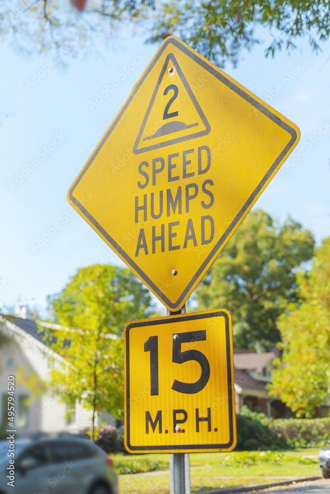Yellow sign about the speed limit and speed humps Stock Photo | Adobe Stock