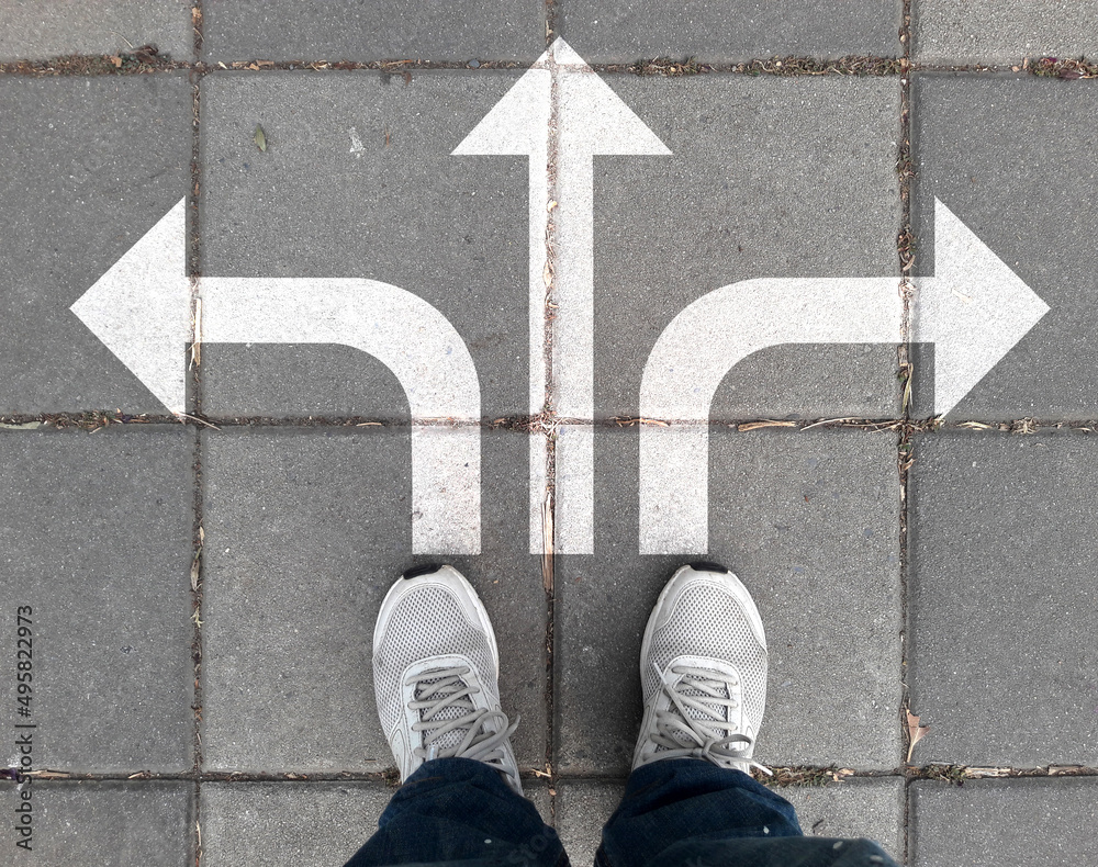 Shoes and arrows pointing in different directions on the road Stock ...