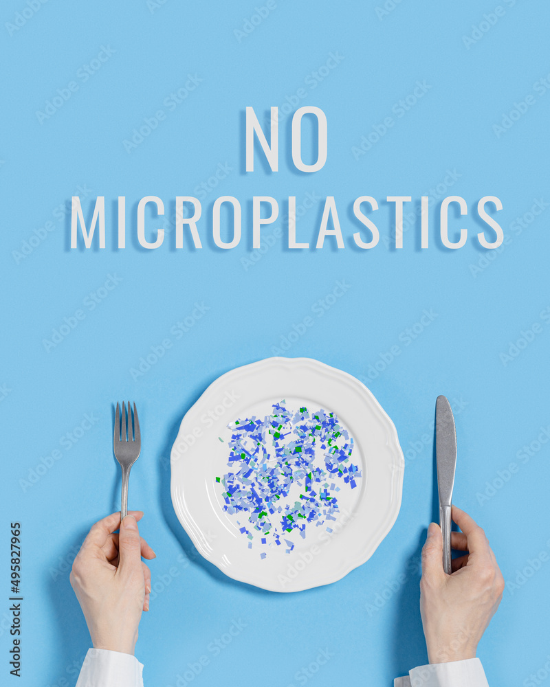 Plate with microplastic pieces as food on blue background. Plastic ...