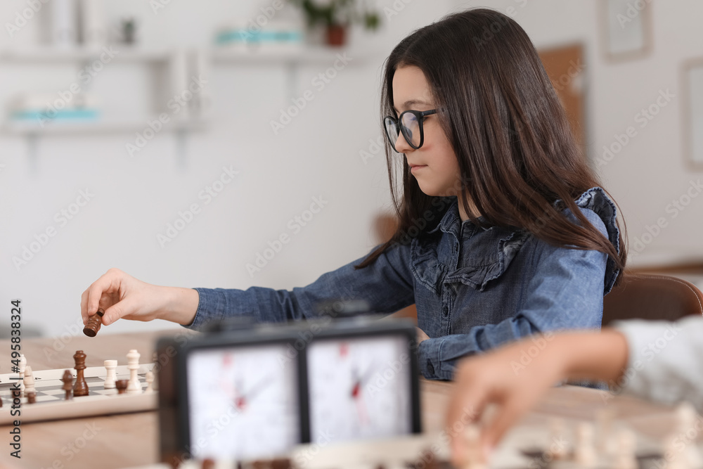 Little girl playing chess during tournament in club Stock Photo | Adobe ...