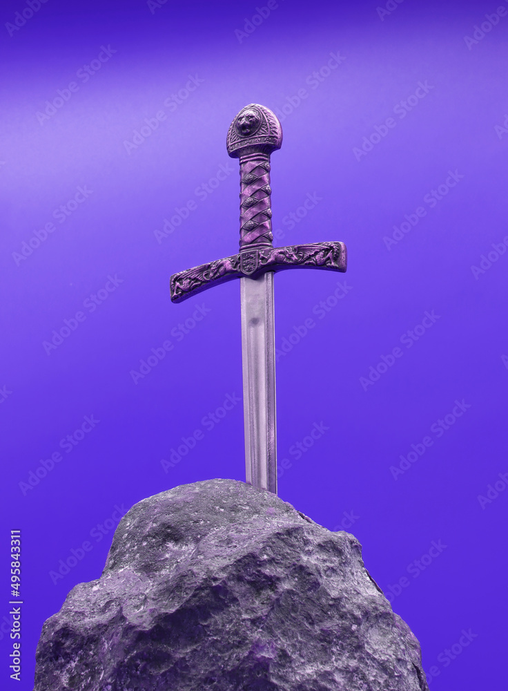 Excalibur, the mythical sword in the stone of King Arthur on purple ...