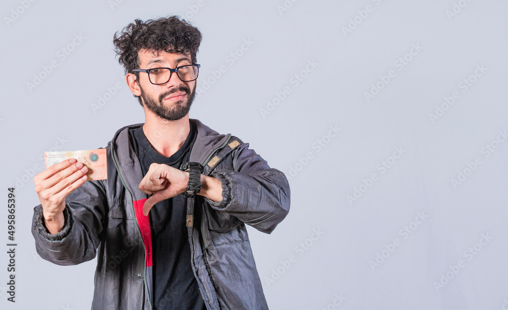 Foto de Sad man holding banknote, Sad man with a banknote with thumb ...
