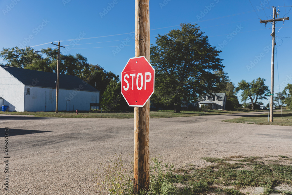 Stop sign at a road intersection. Stock Photo | Adobe Stock