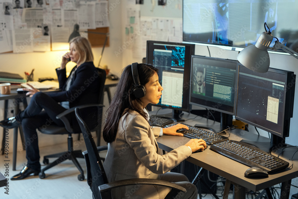 Serious female agent of intelligence service sitting in front of ...