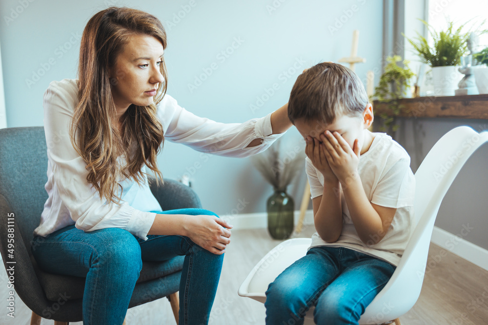 Parenthood and child development, young worried mother comforting ...
