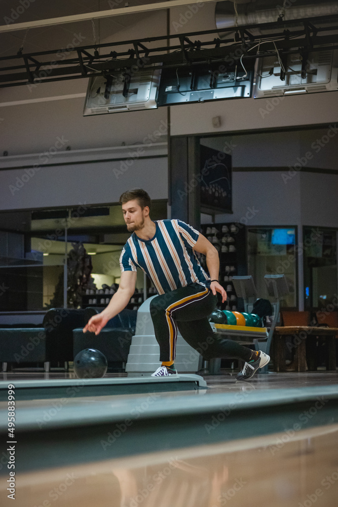 Professional bowler throws his throw and is in position to watch his ...