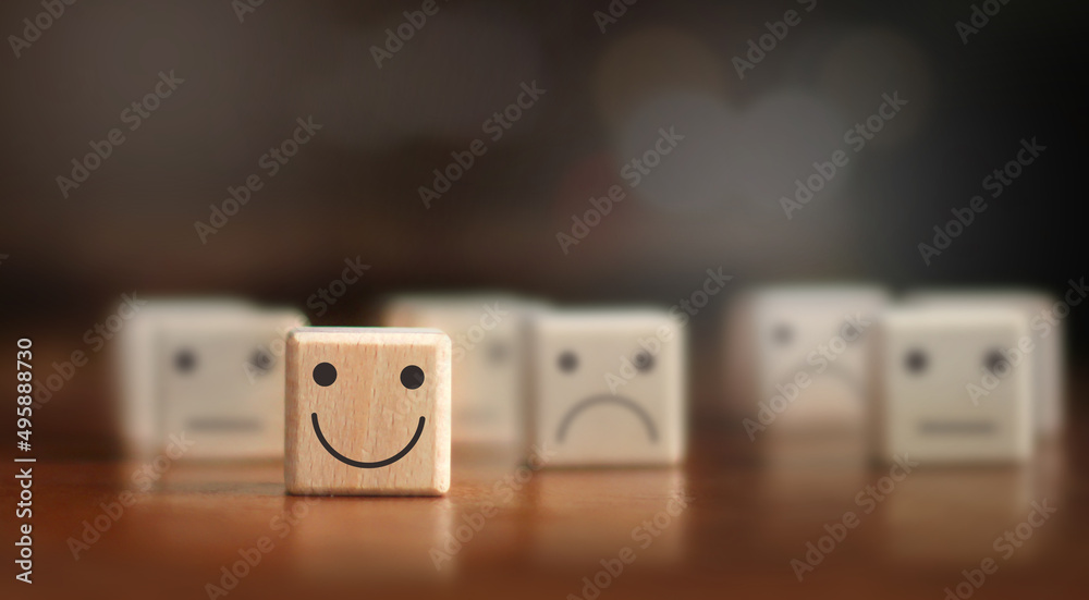 wooden cube blocks, concepts, emotions and thoughts A clearly smiling ...