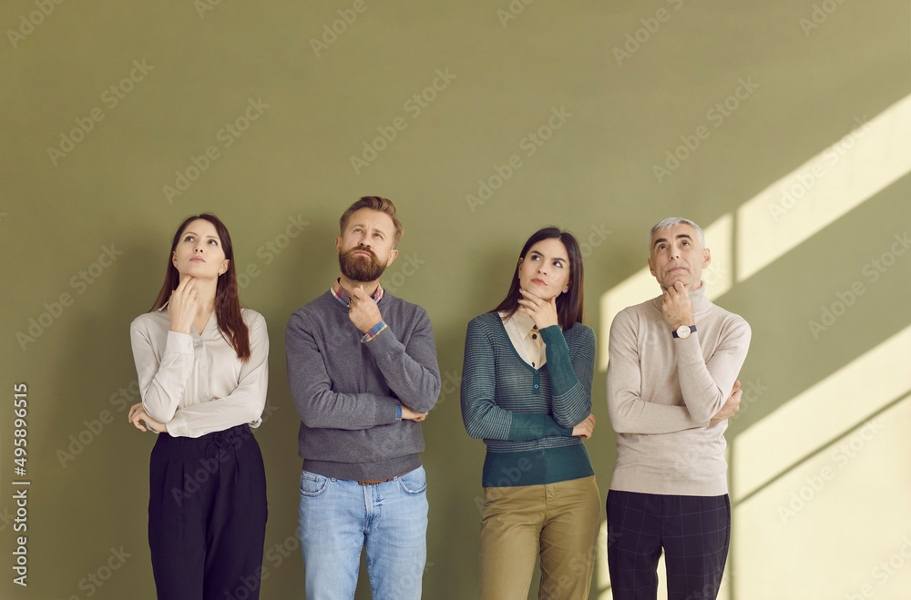 Portrait of group of people pondering or making decision while standing ...