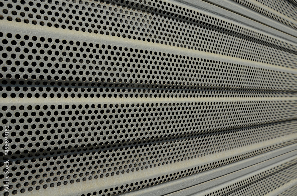 noise barrier made of metal perforated sheet metal slats. gray and ...