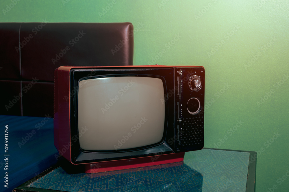 Retro old TV with blank screen in bedroom in front of green wall ...