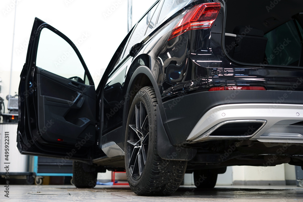 Moscow Russia - March 2022: A modern black SUV is standing in a car service station waiting for ...