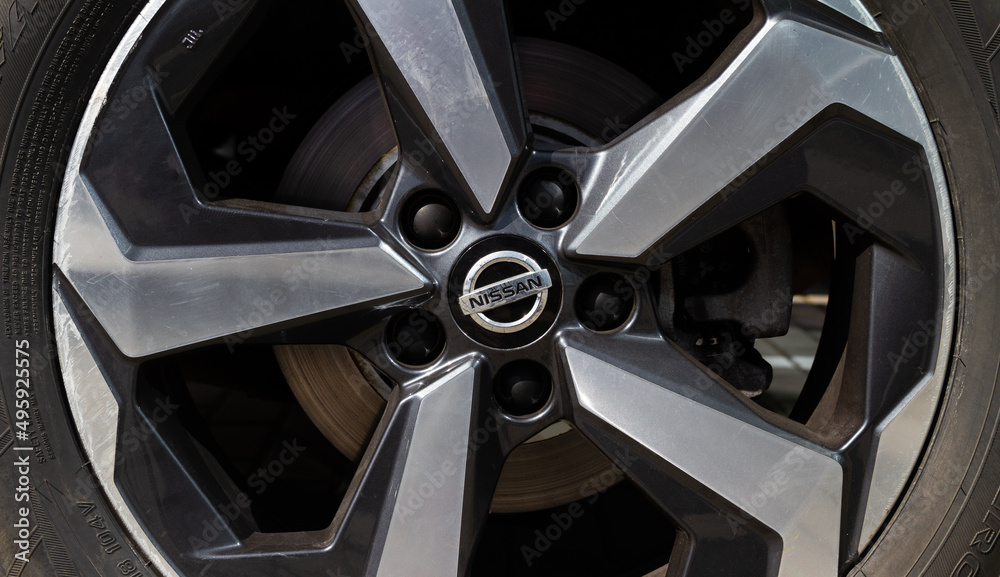 Nissan car alloy wheel with logo sign. Emblem badge logotype on ...