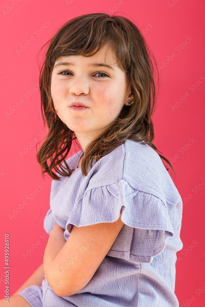 Cute girl pouting lips in bright studio Stock Photo | Adobe Stock