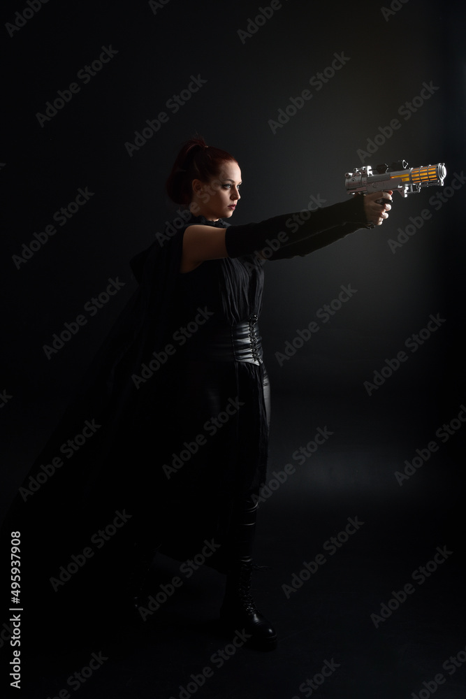 Full length portrait of pretty redhead female model wearing black ...