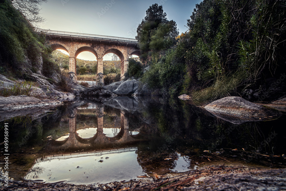 Paisaje con un puente y su reflejo en el río de Onteniente Stock Photo ...