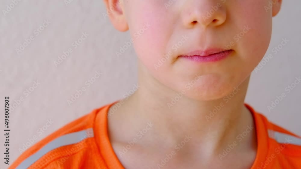 close-up part of face of small child, boy of 8 years old, lips, mouth ...