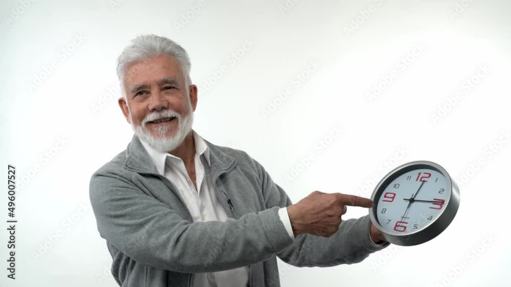 Portrait of an elderly caucasian stylish man points to the clock ...