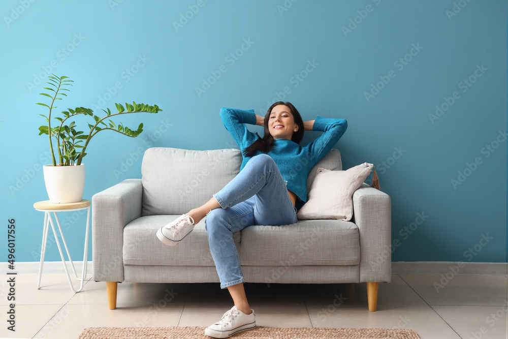 Beautiful woman resting on couch at home Stock Photo | Adobe Stock