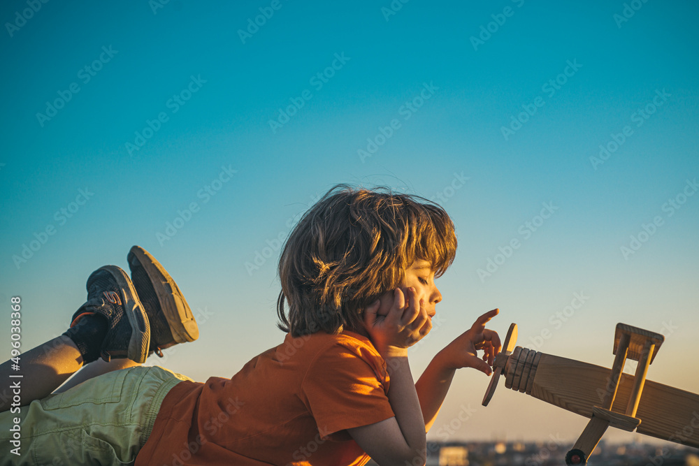 Little boy with wooden plane, boy wants to become pilot and astronaut ...